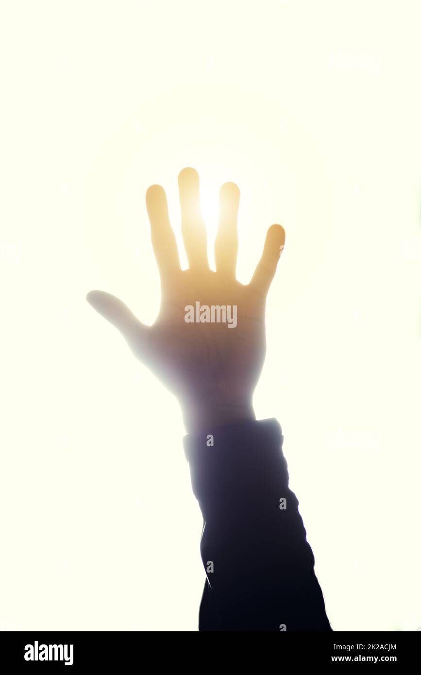 Its bright out. Cropped shot of a persons hand raised and blocking the ...