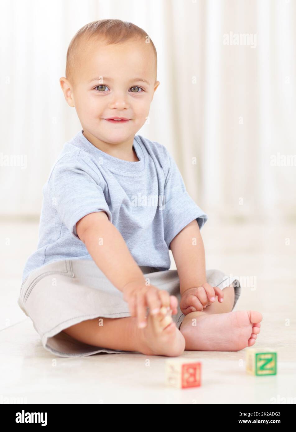 Time to play. Full length shot of a cute little boy playing at home ...