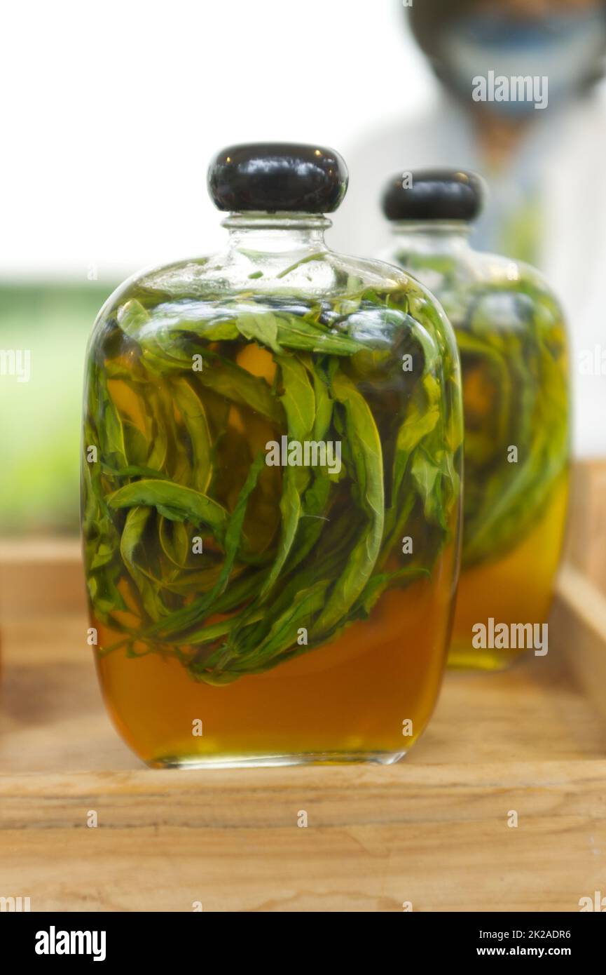 Dried cannabis pickled with honey in bottle Stock Photo - Alamy