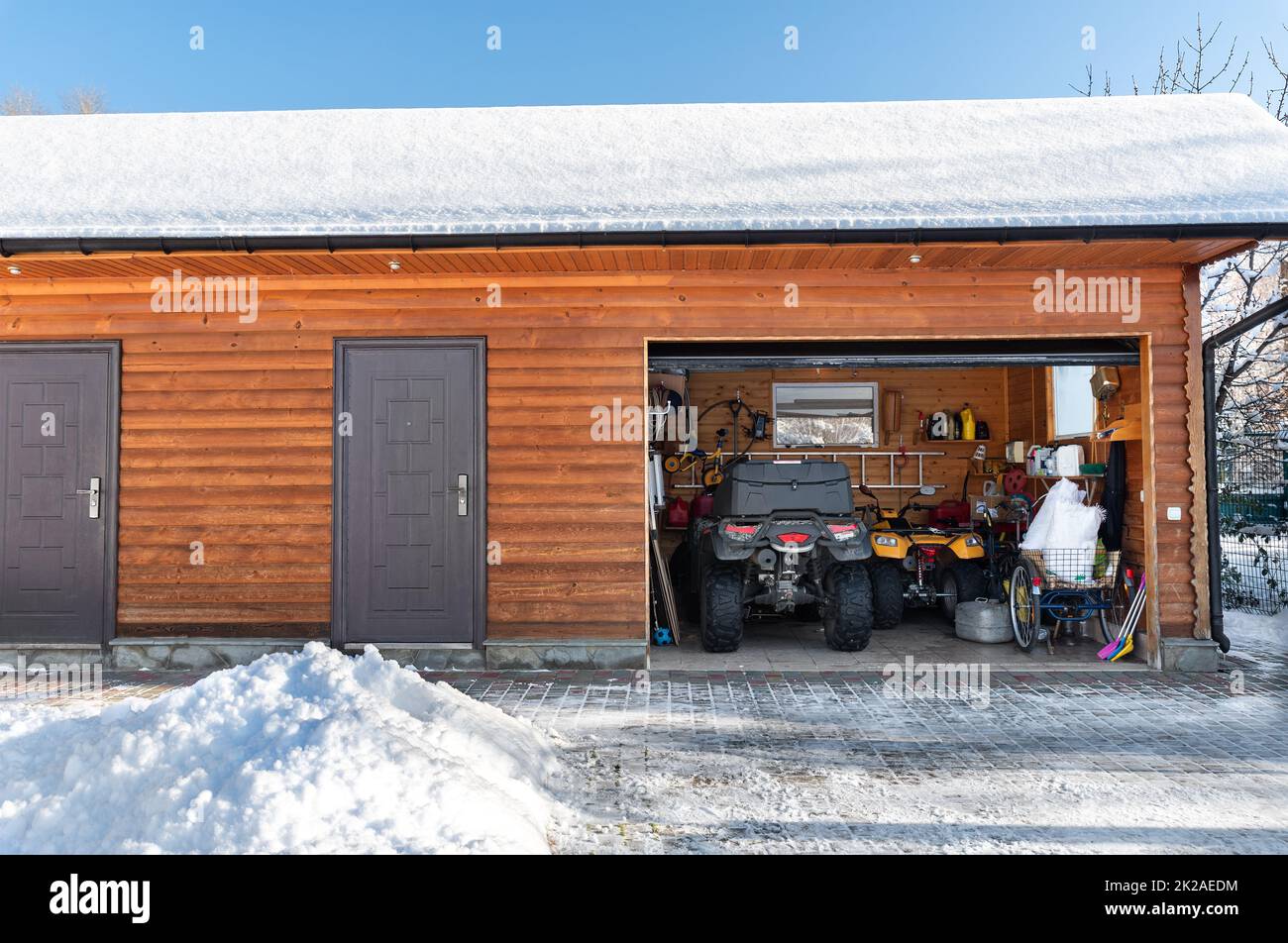 Facade view open door ATV home garage with quad bikes offroad vehicle ...