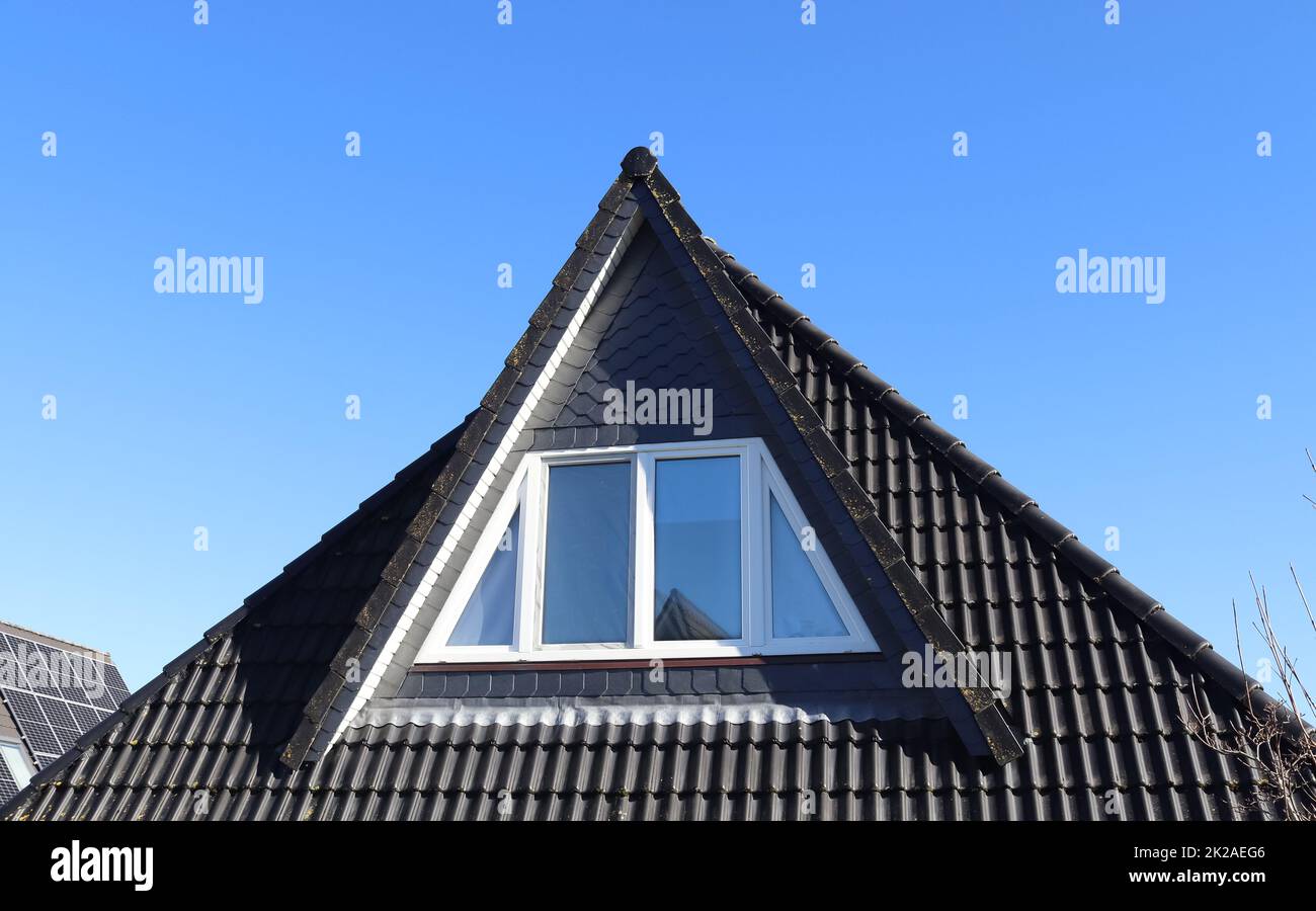 Open roof window in velux style with black roof tiles Stock Photo - Alamy