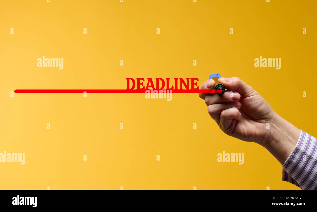 red line with the inscription deadline and a female hand with a marker ...