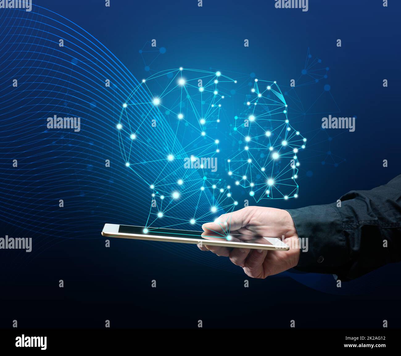 a male hand holds a tablet and a holographic drawing of a robot head ...