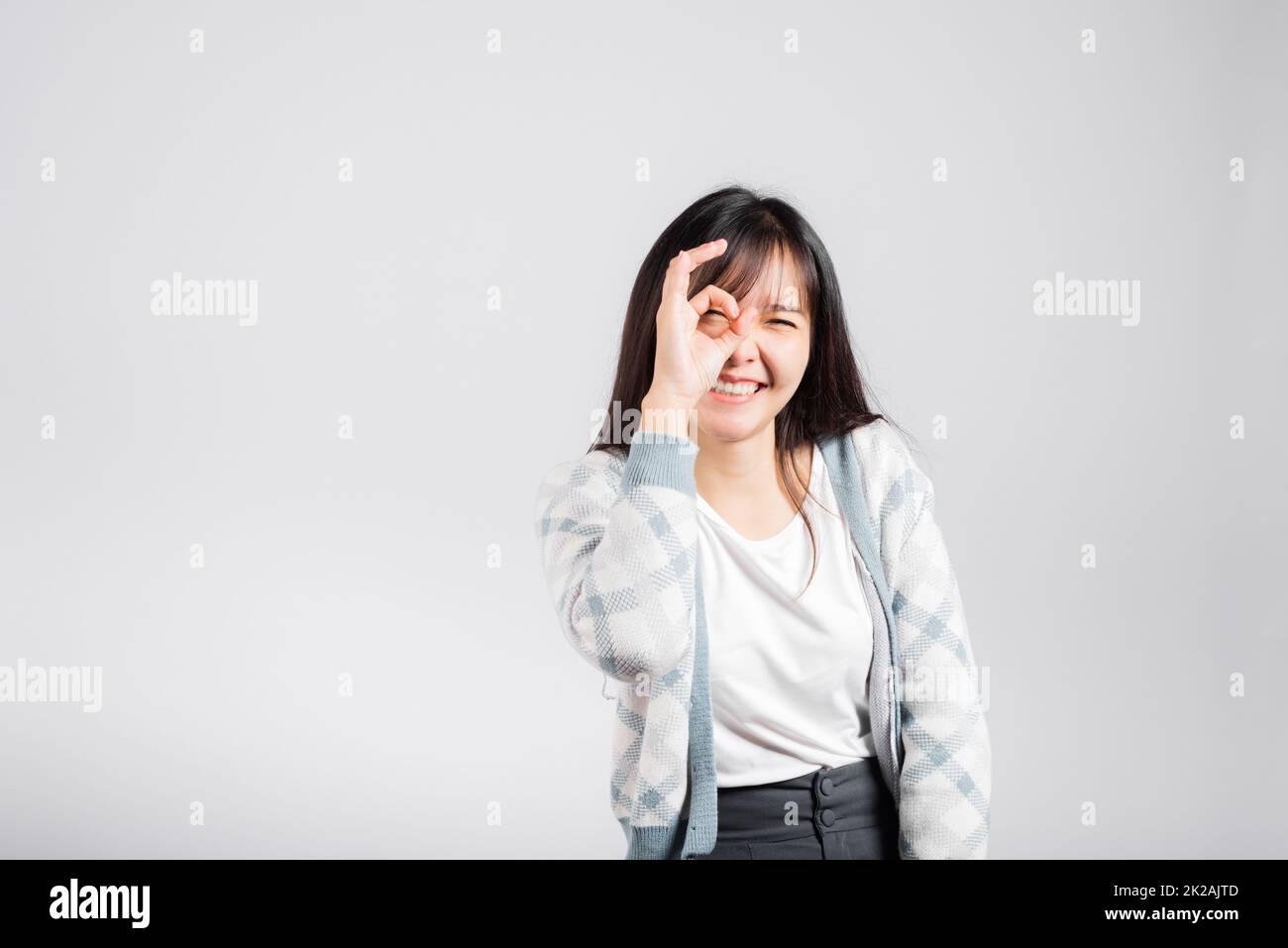 Woman smiling showing made finger OK symbol sign to agree Stock Photo ...