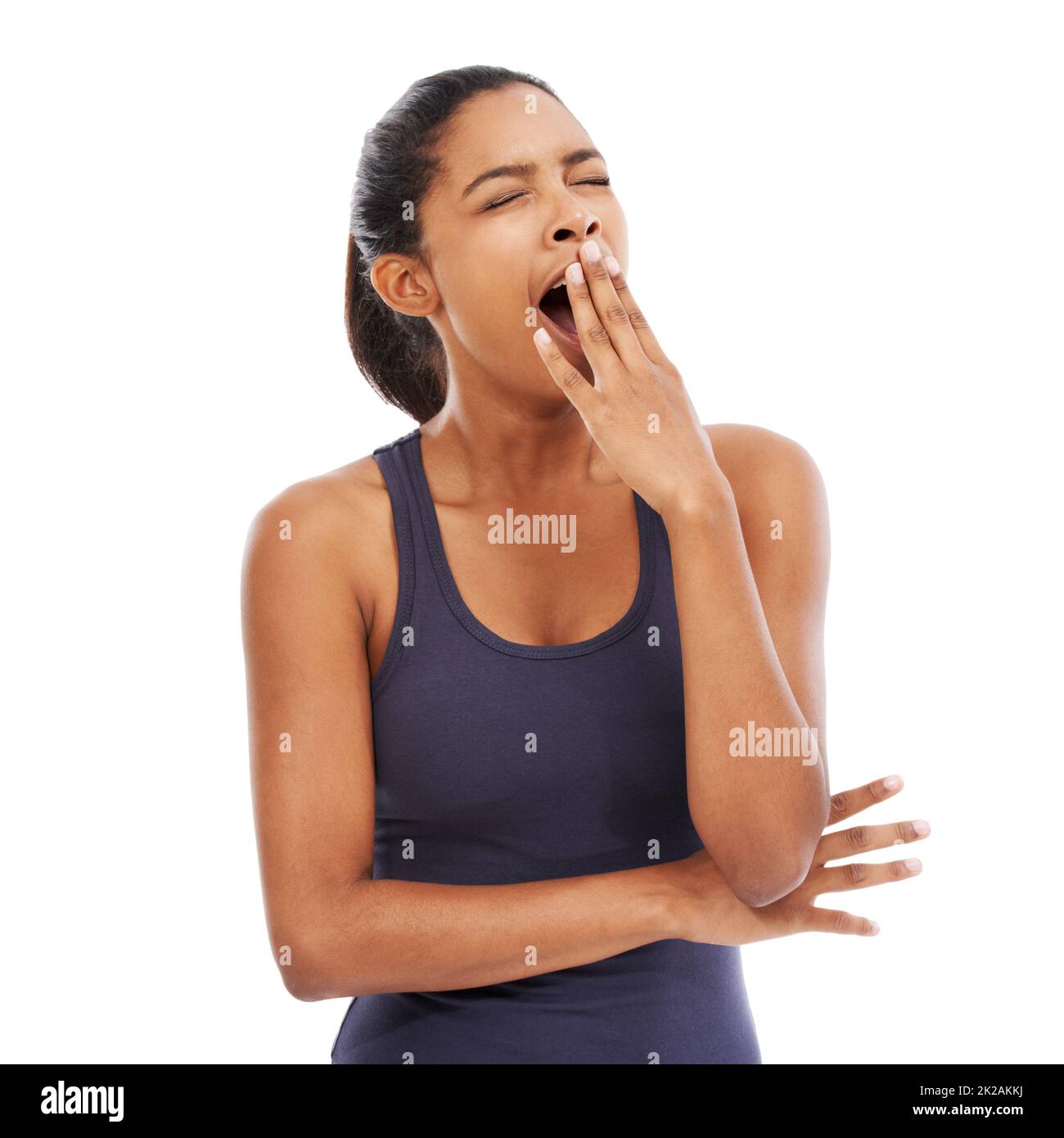 She needs a break. A tired young woman yawning after an exhausting ...