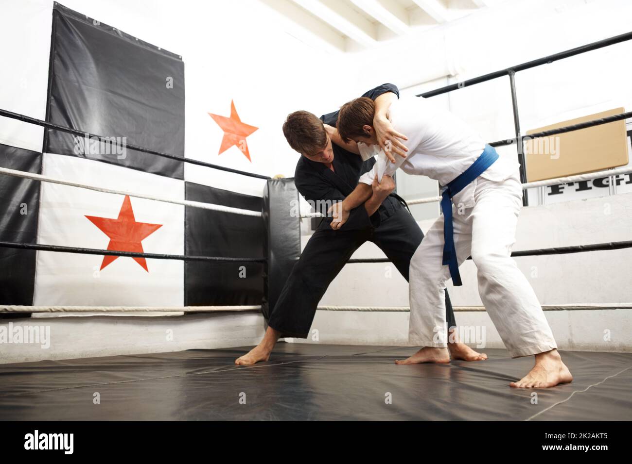 Two stars in the ring. Full length shot of two martial artists sparring ...