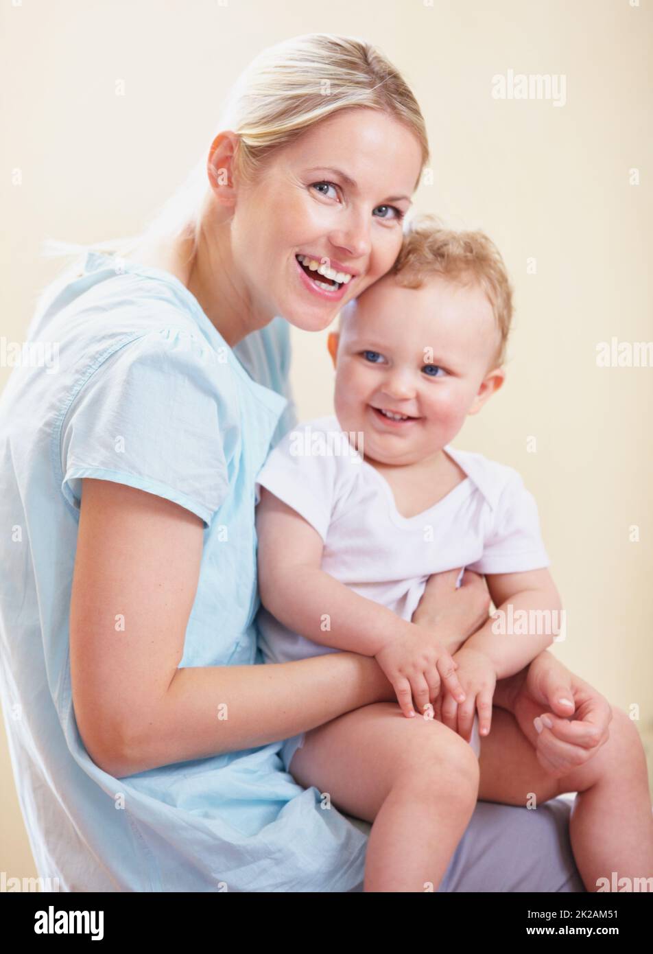 Portrait of motherhood. A portrait of a smiling mother sitting with her ...