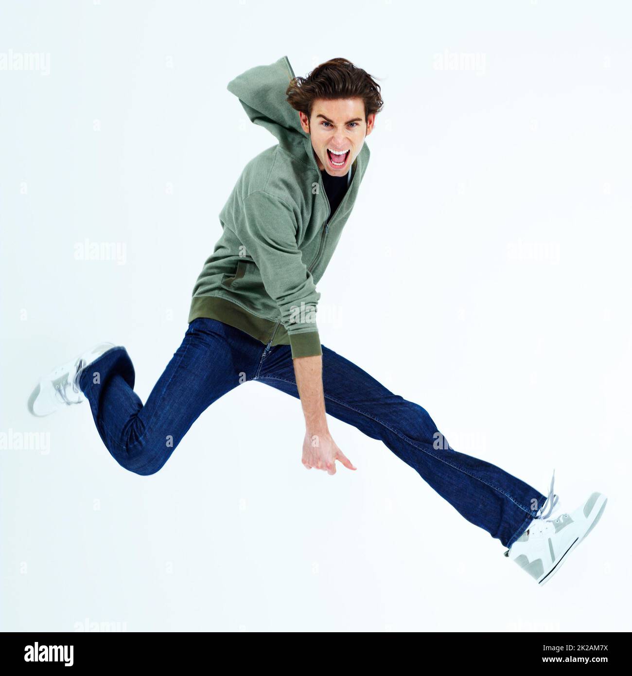 Yeah - Enjoying freedom. Portrait of a young man jumping out and ...