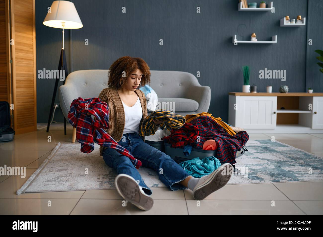 Young woman packing luggage preparing for vacation Stock Photo - Alamy