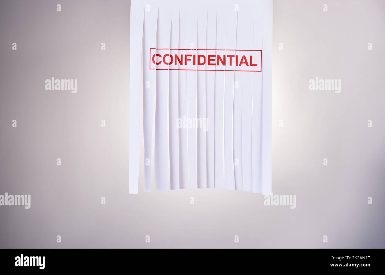 No evidence, no problem. Studio shot of a sheet of shredded paper Stock ...