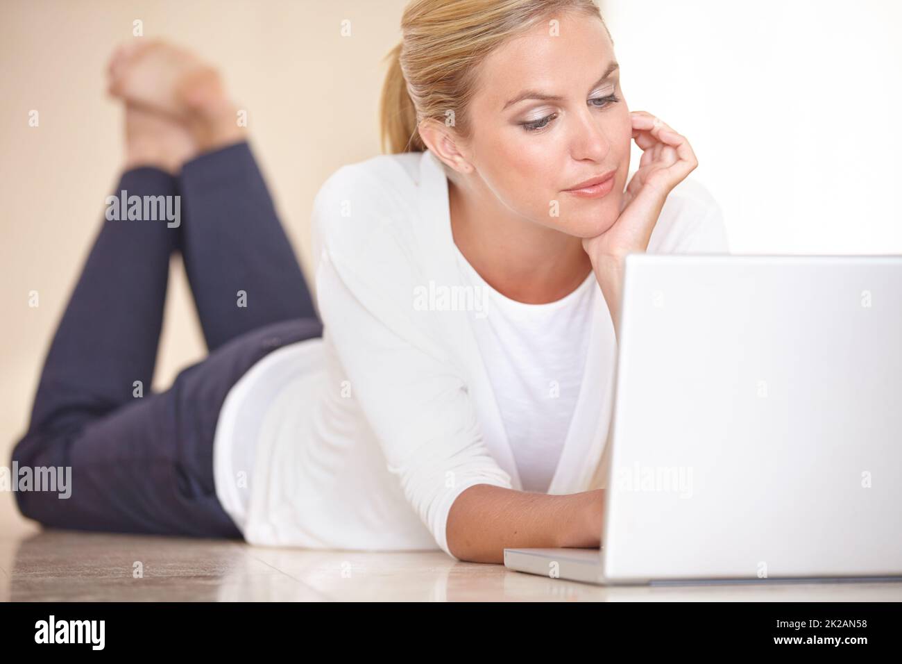 Woman lying on floor laptop hi-res stock photography and images - Alamy