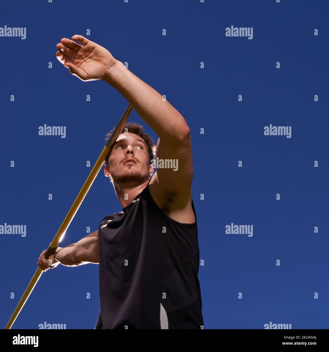 this is going the distance. Shot of a lone man throwing a javelin ...