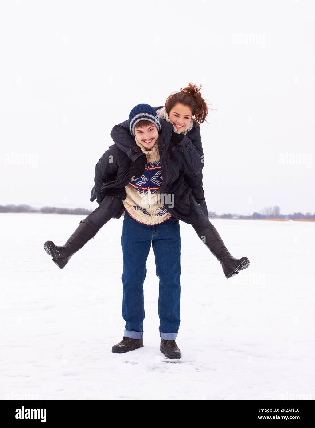 Loving this weather. A cute young couple being playful in on the ice of ...