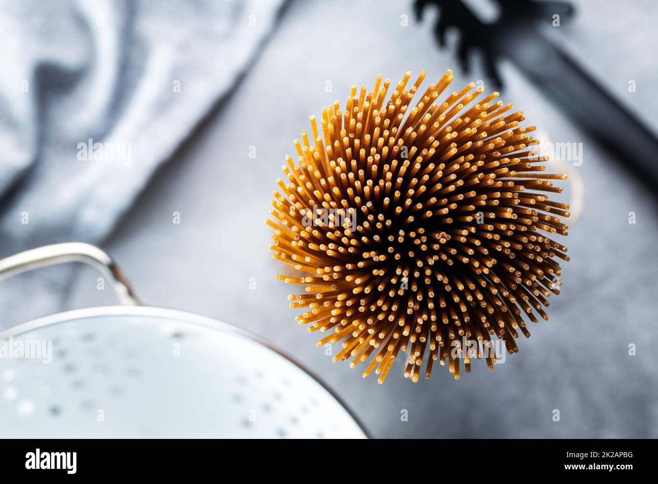 Uncooked whole grain spaghetti. Raw pasta on kitchen table Stock Photo ...