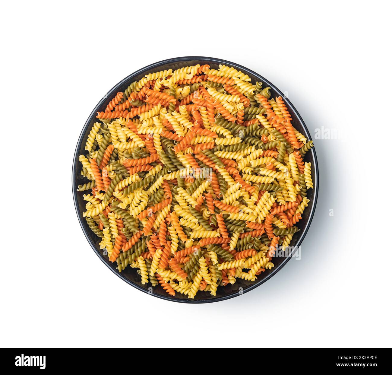 Three colors fusilli pasta in bowl. Colorful italian raw pasta isolated ...