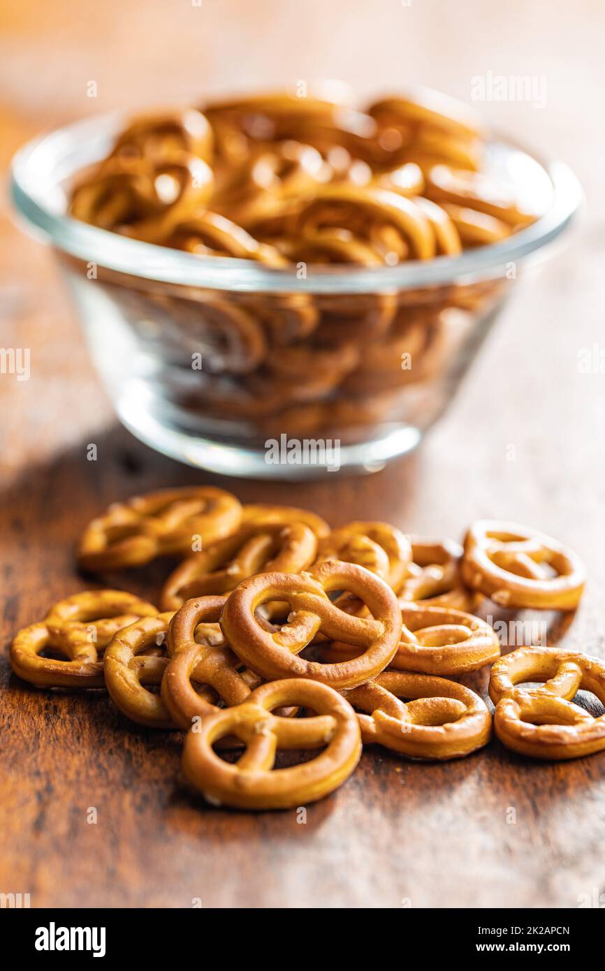 Mini pretzels. Crusty salted snack on wooden table Stock Photo - Alamy