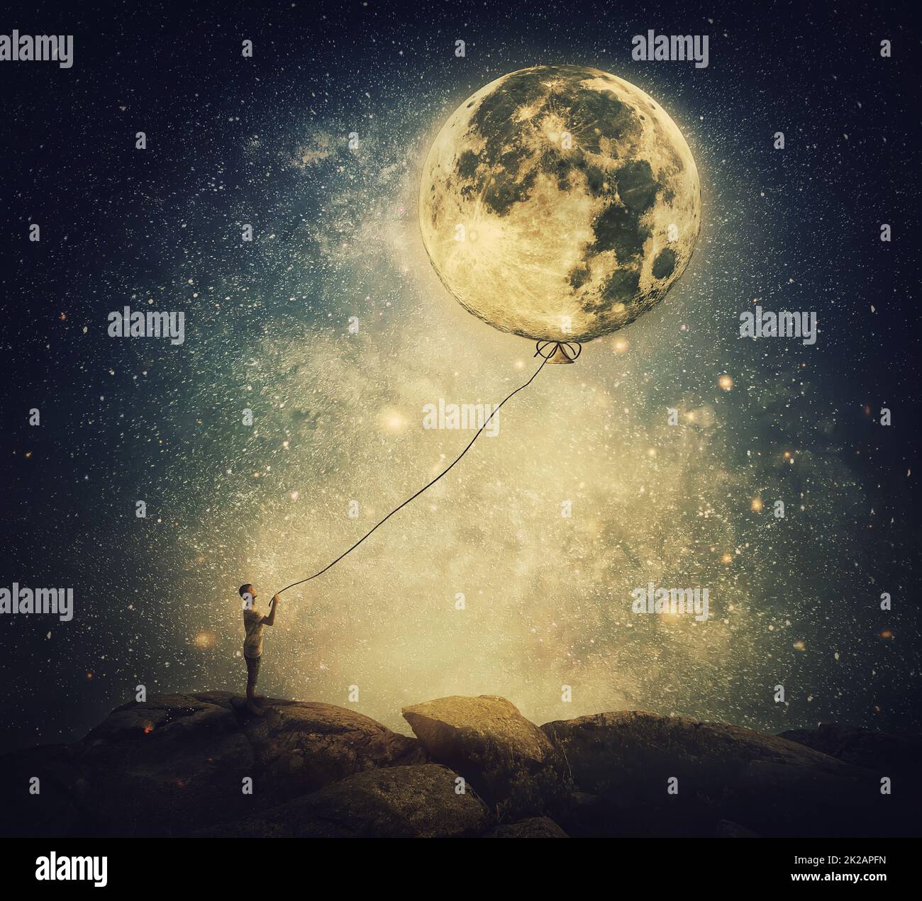 Surreal and inspirational scene with a person holding the full moon as ...