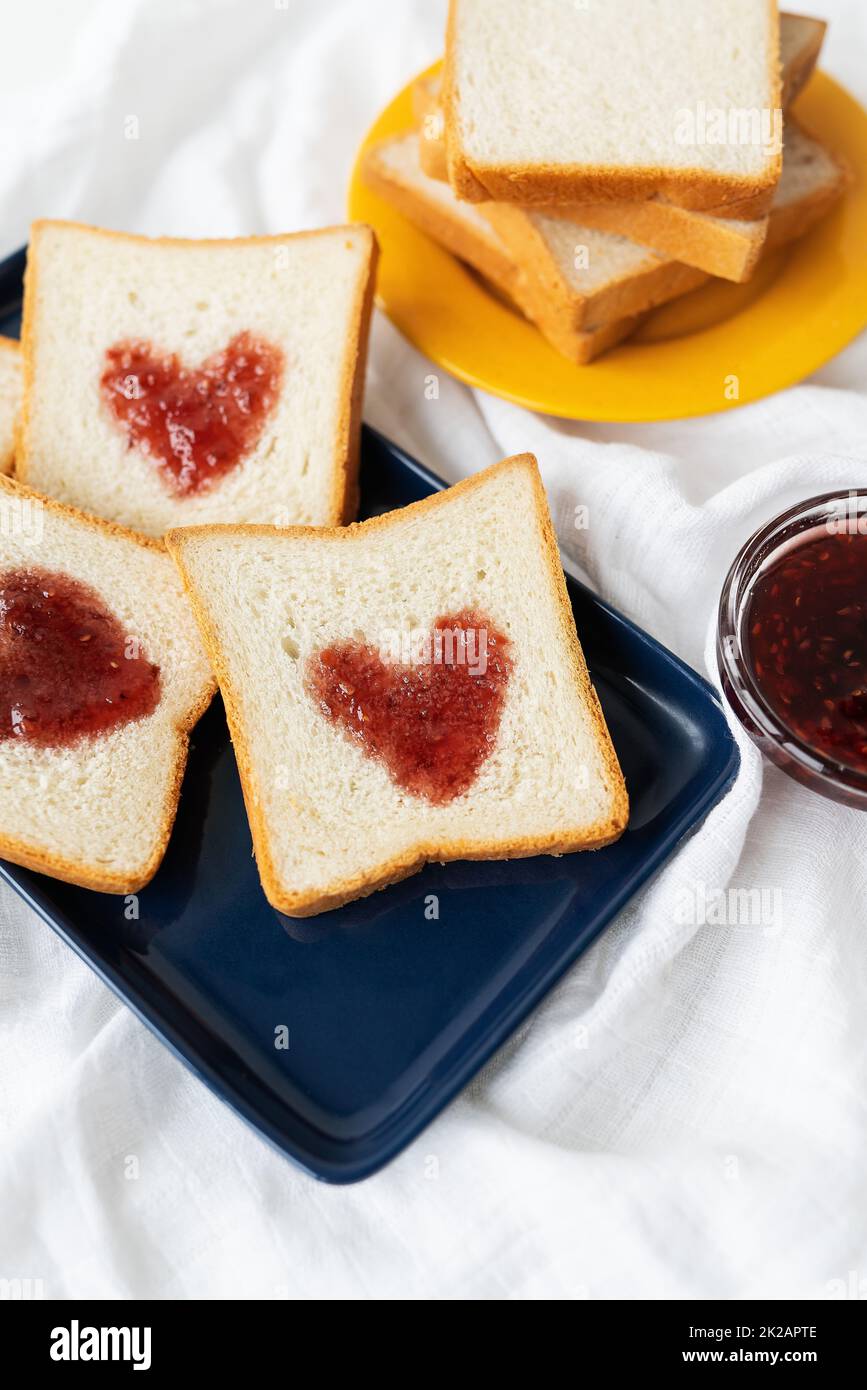 Toast on which the heart is made of jam. Surprise breakfast concept in ...