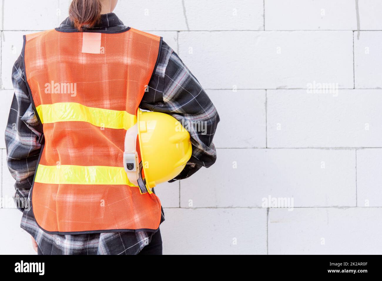 Back view of engineer, architect, supervisor worker wear reflective ...