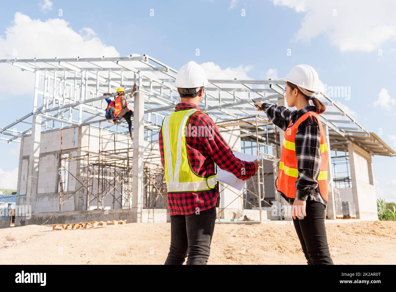 Back two architect and client discussing help create plan with ...