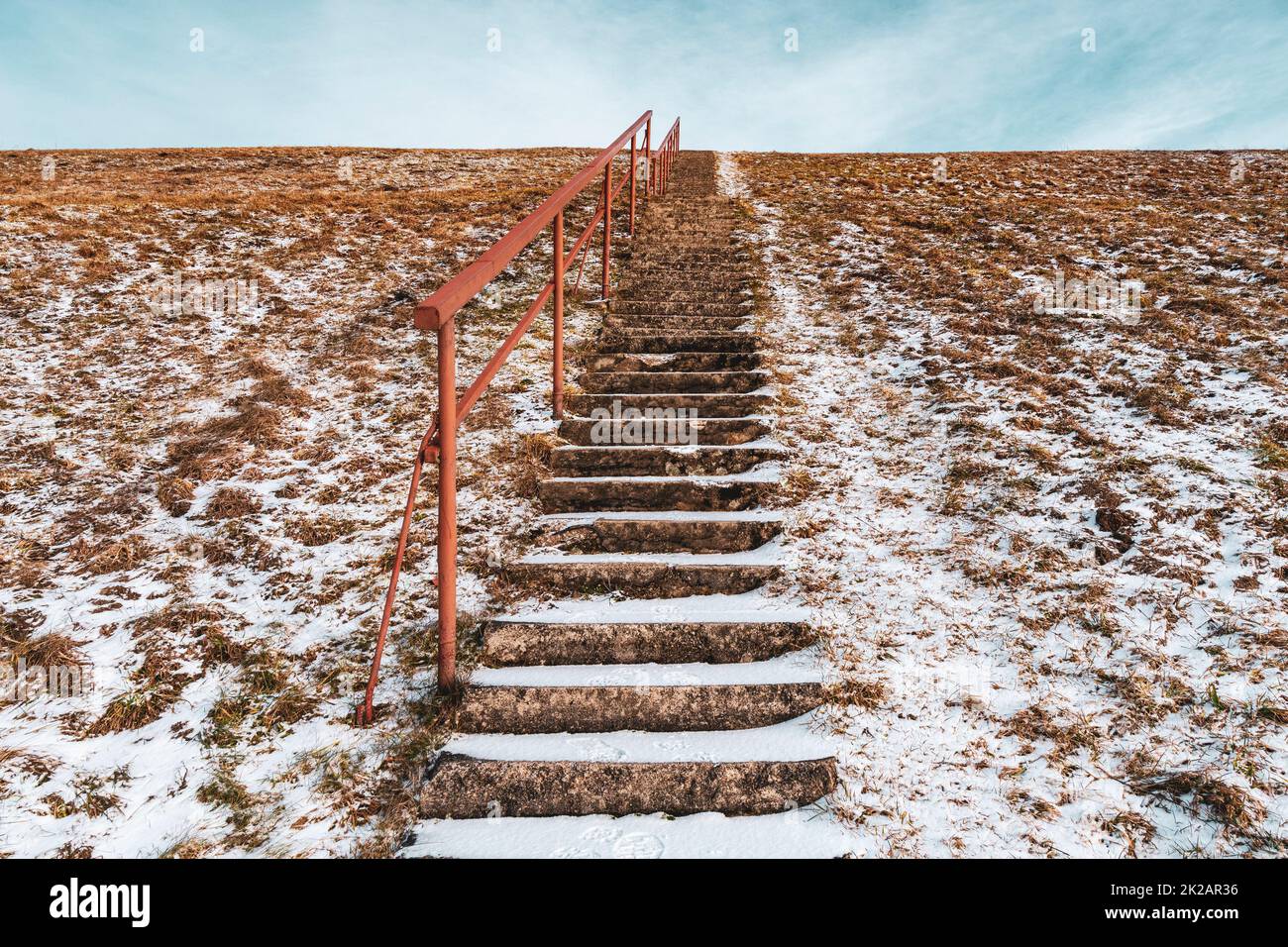 Stairs stretching up to a snowy hill Stock Photo - Alamy