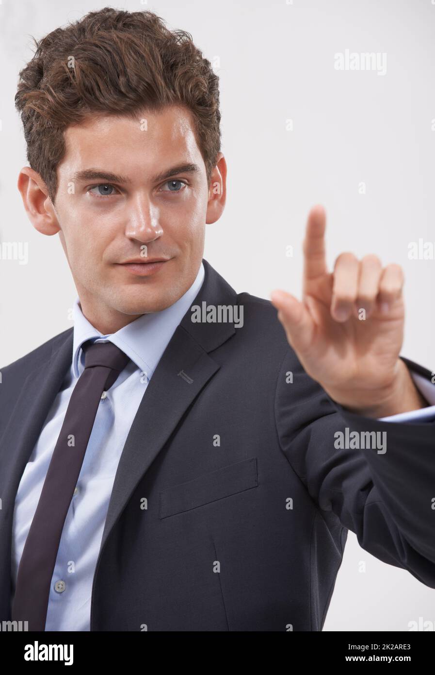 The future at my fingertips. A handsome young businessman interacting ...
