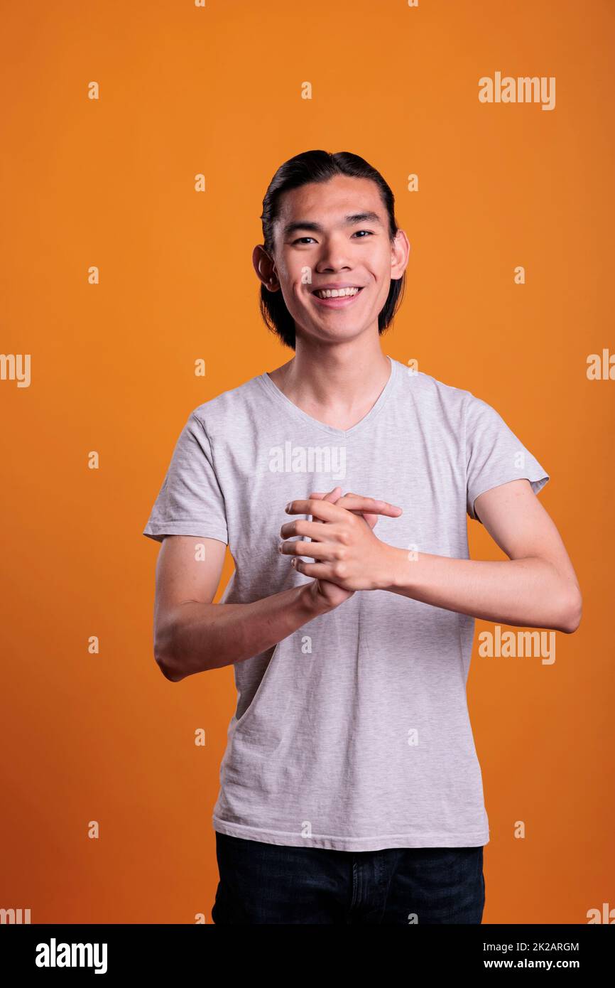 Young Adult Cheerful Smiling Asian Man Clapping Hands Portrait