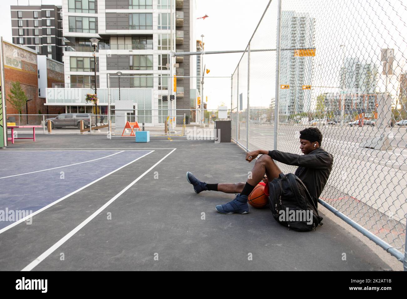 Man lean fence hi-res stock photography and images - Alamy