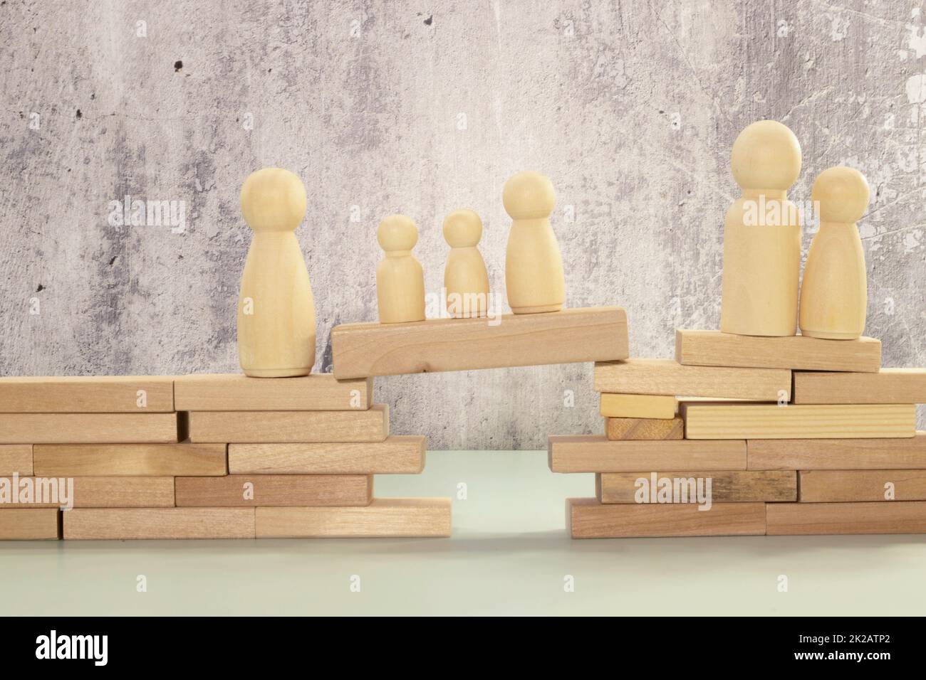 The child was lost in the crowd. A crowd of wooden figures of people ...