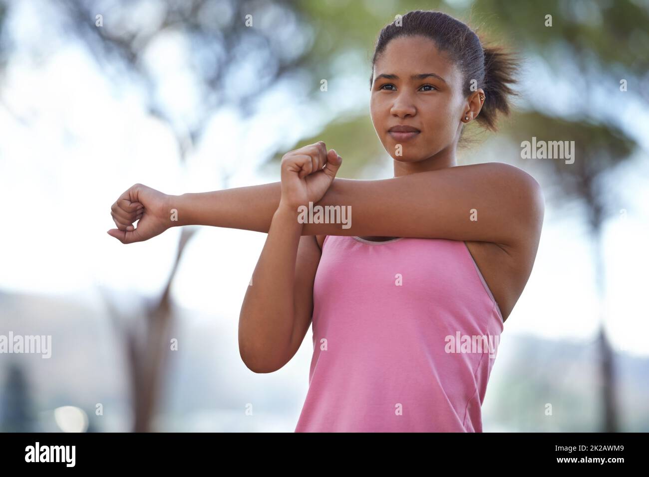 Making sure her muscles are ready for the run. A young teenager warming ...