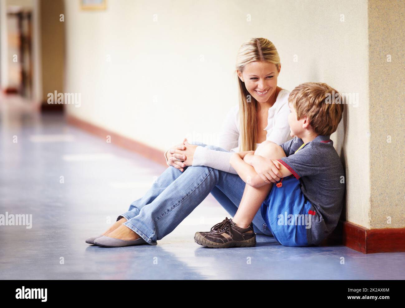 Teacher Talking To Student In Hallway