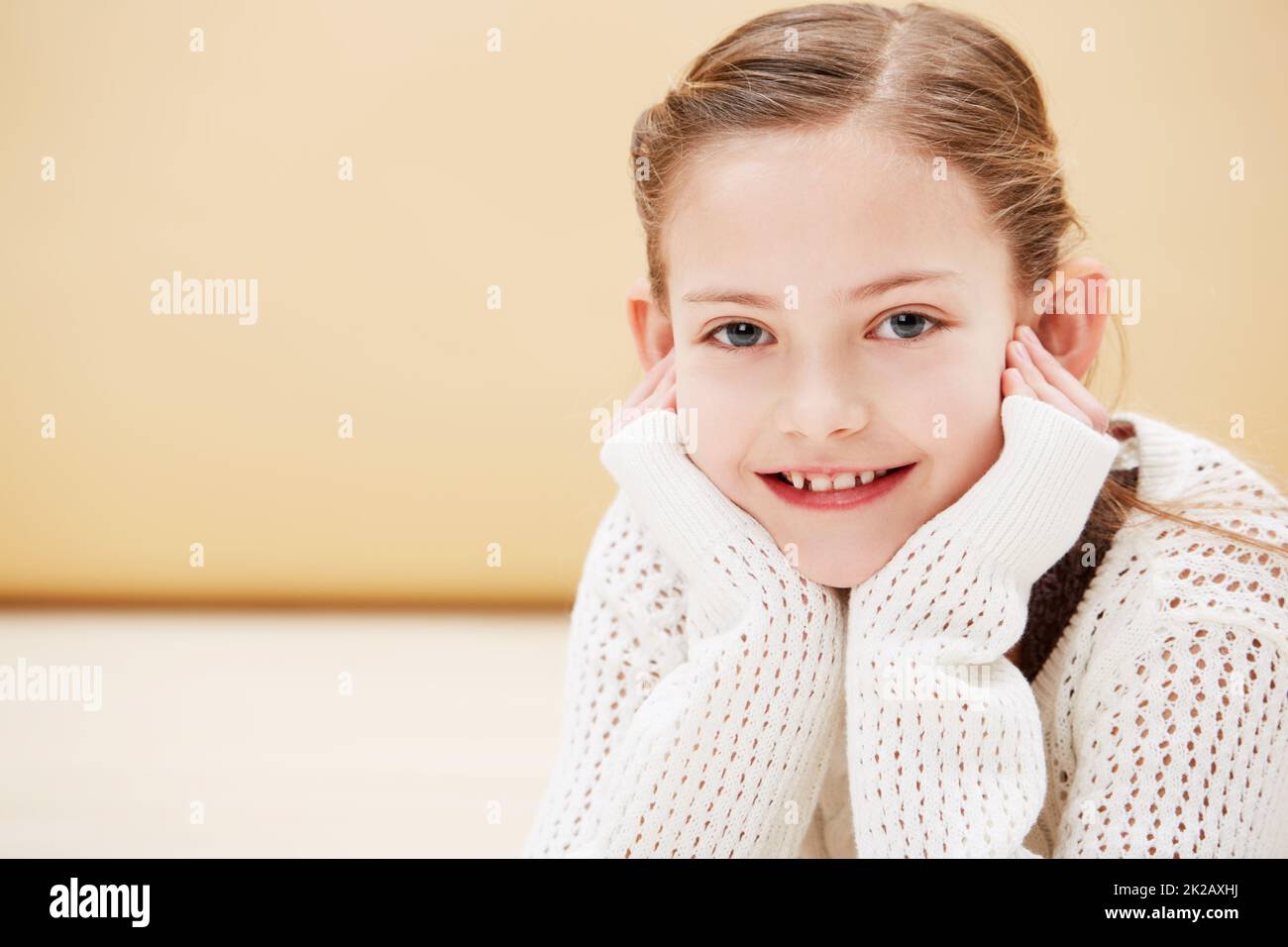 Giving you a sweet smile. Cropped portrait of a cute little girl ...