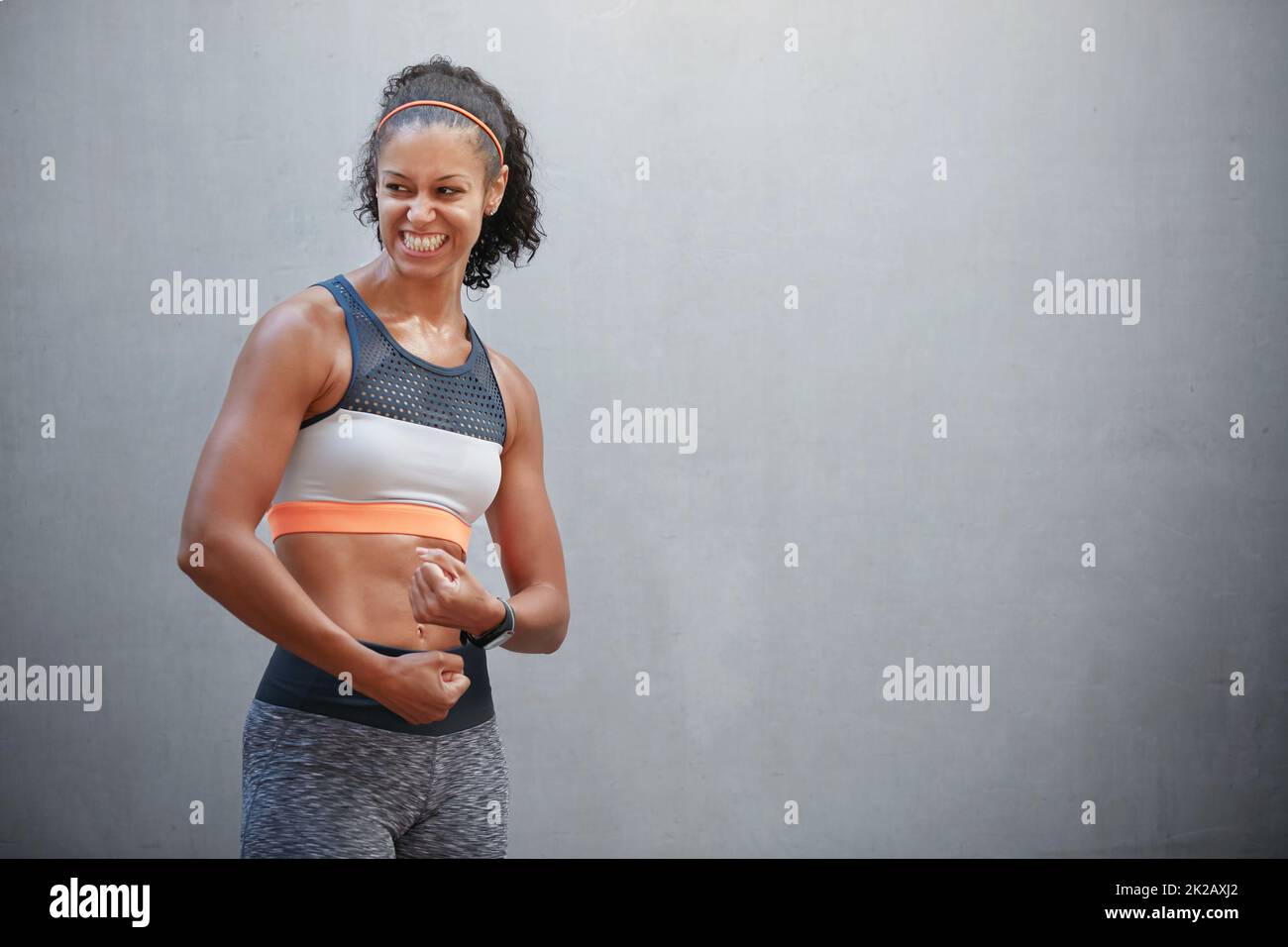 Woman flexing arms hi-res stock photography and images - Alamy