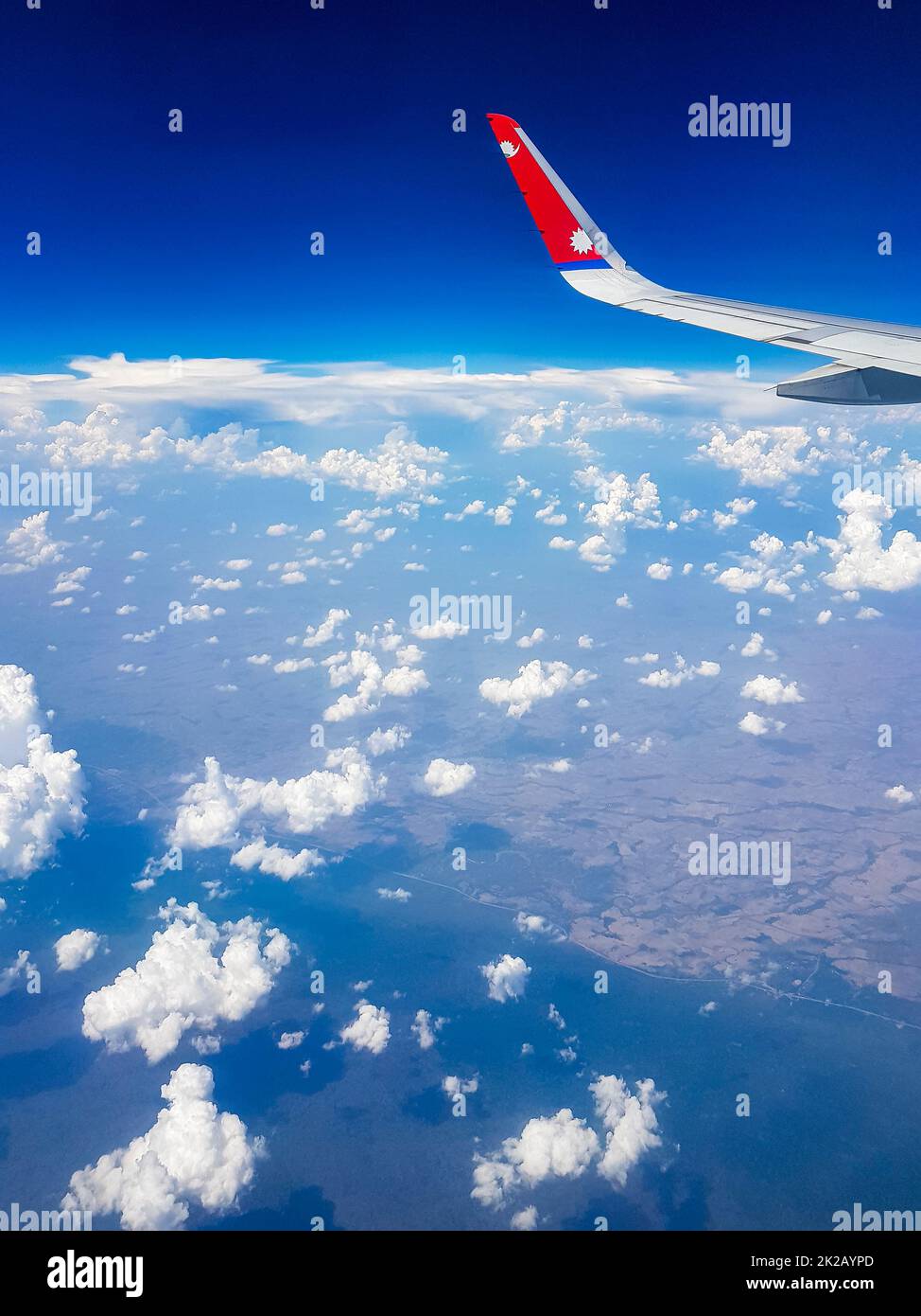 Flying with Nepal Airline above clouds over countryside of Thailand ...