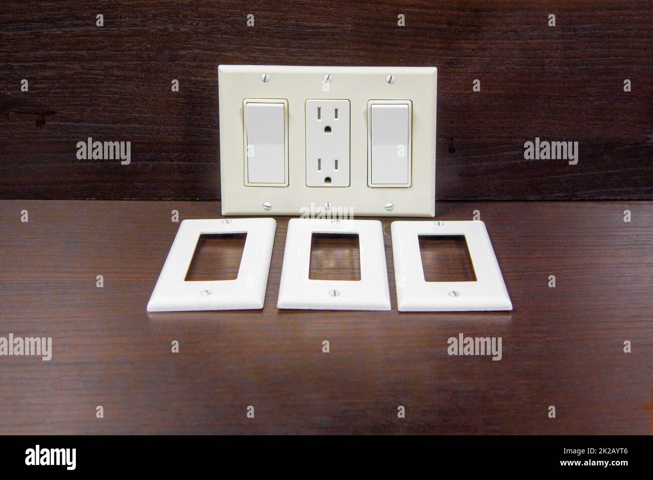Switches with a socket on one board and spare covers Stock Photo - Alamy