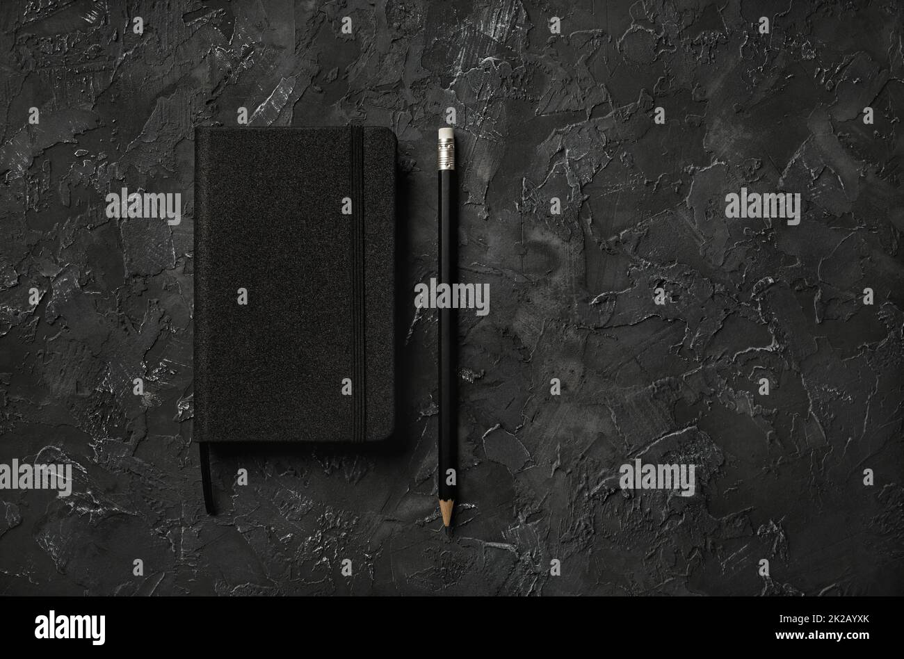Black notepad, pencil Stock Photo - Alamy