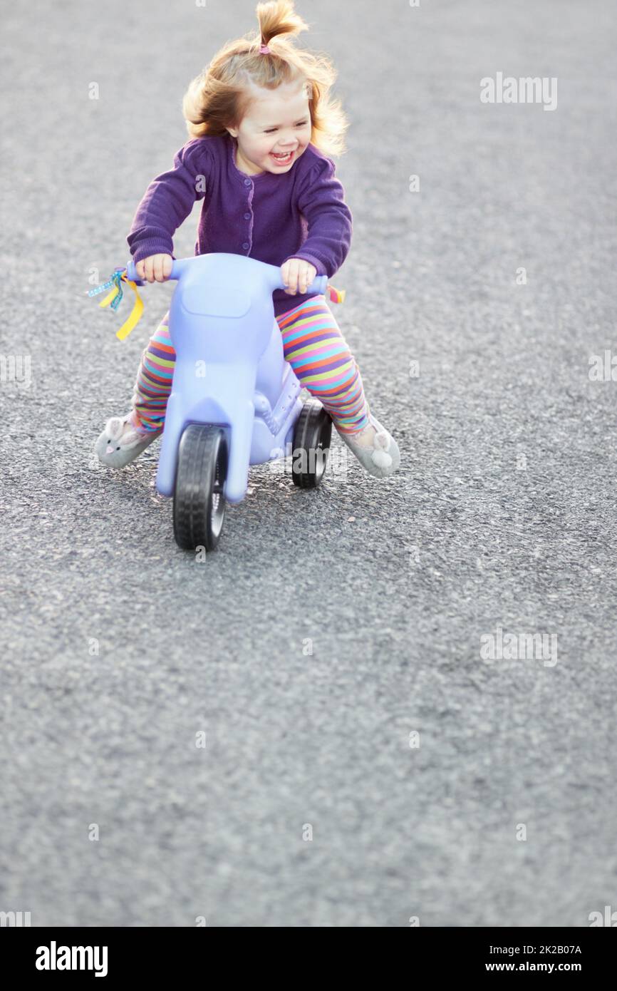 Happy cute girl riding tricycle hi-res stock photography and images - Alamy
