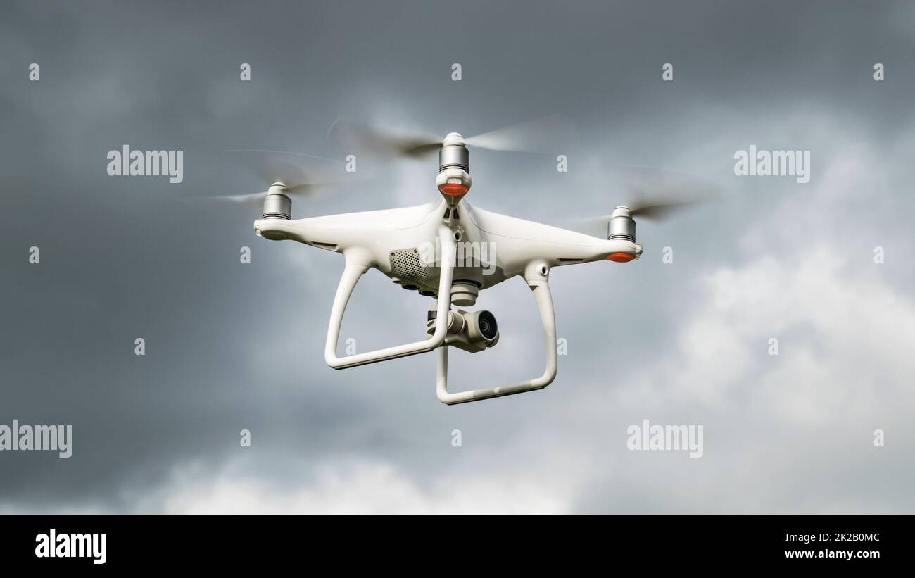 Drone DJI Phantom 4 in flight. Dron against the cloudy sky. The flight ...