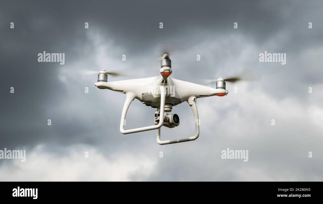 Drone DJI Phantom 4 in flight. Dron against the cloudy sky. The flight ...