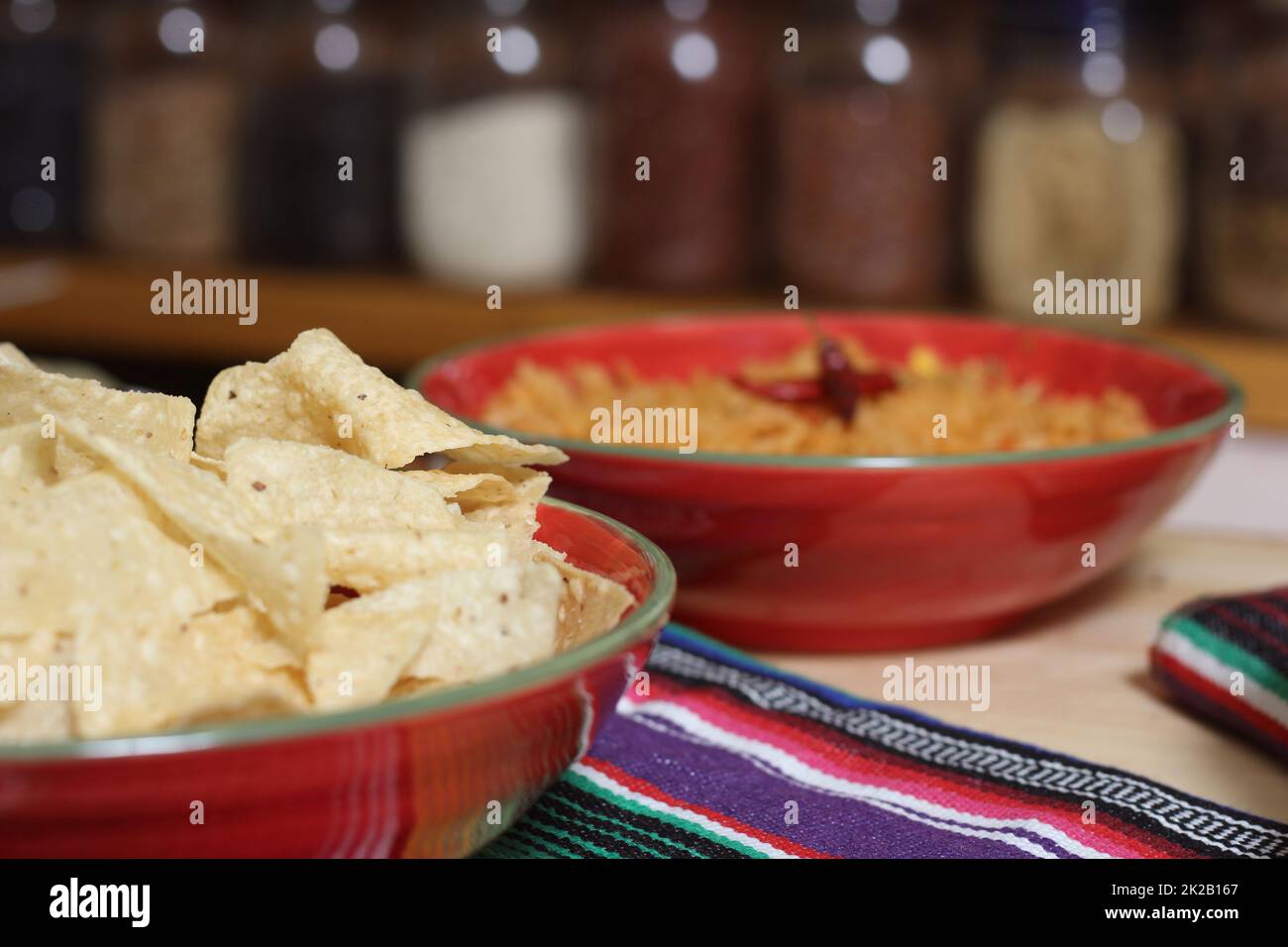 Fresh Bowl of Mexican Rice and Chips With Spicy Peppers and Jars of ...
