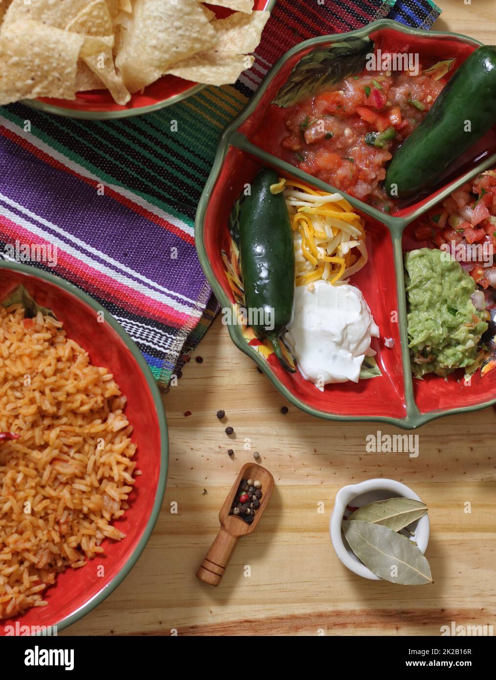 Fresh Bowl of Mexican Rice and Chips With Spicy Peppers and Jars of ...