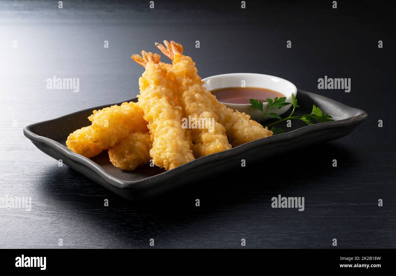 Shrimp tempura on a plate placed against a black background Stock Photo ...