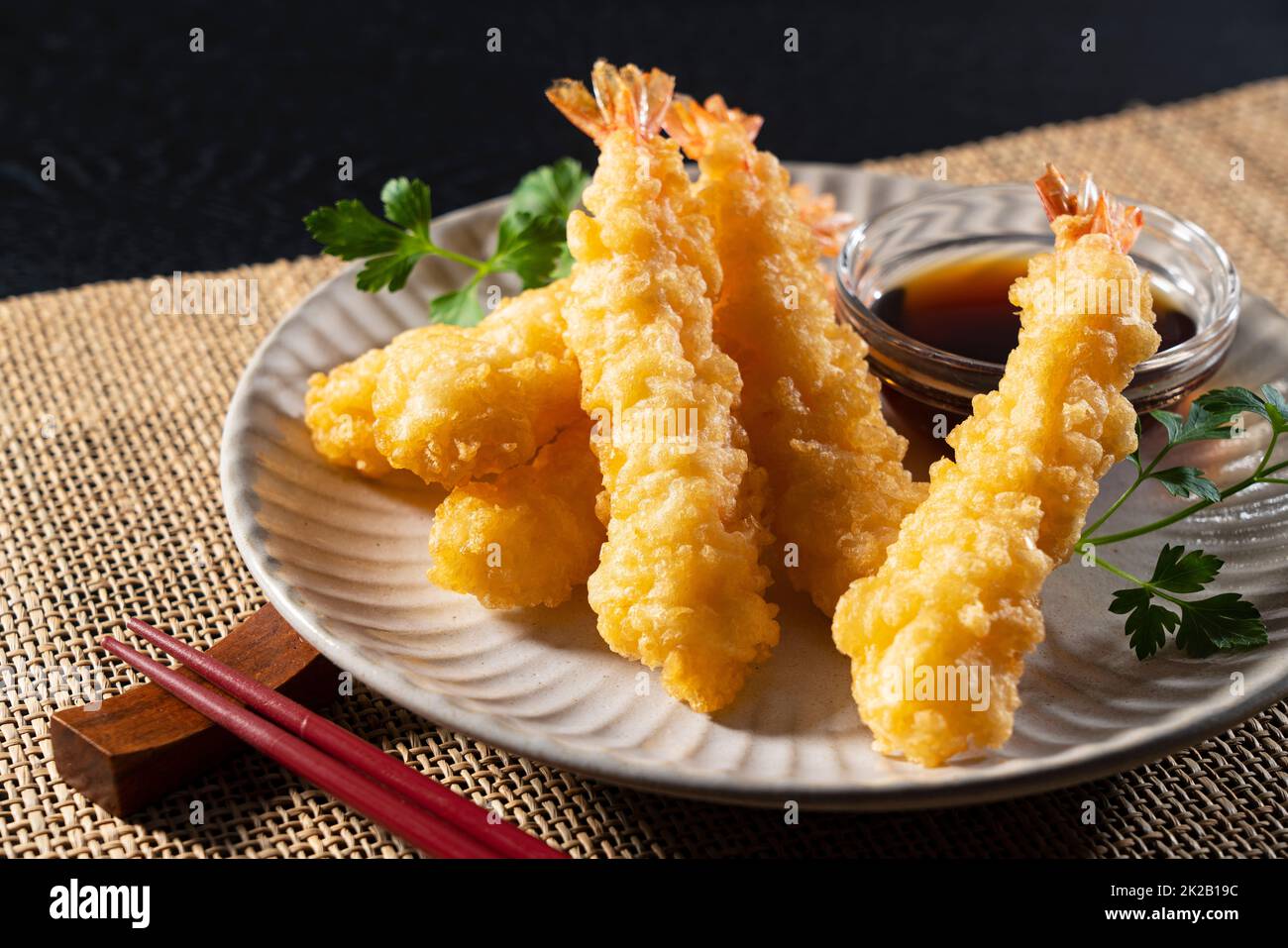 Shrimp tempura on a plate placed against a black background Stock Photo ...