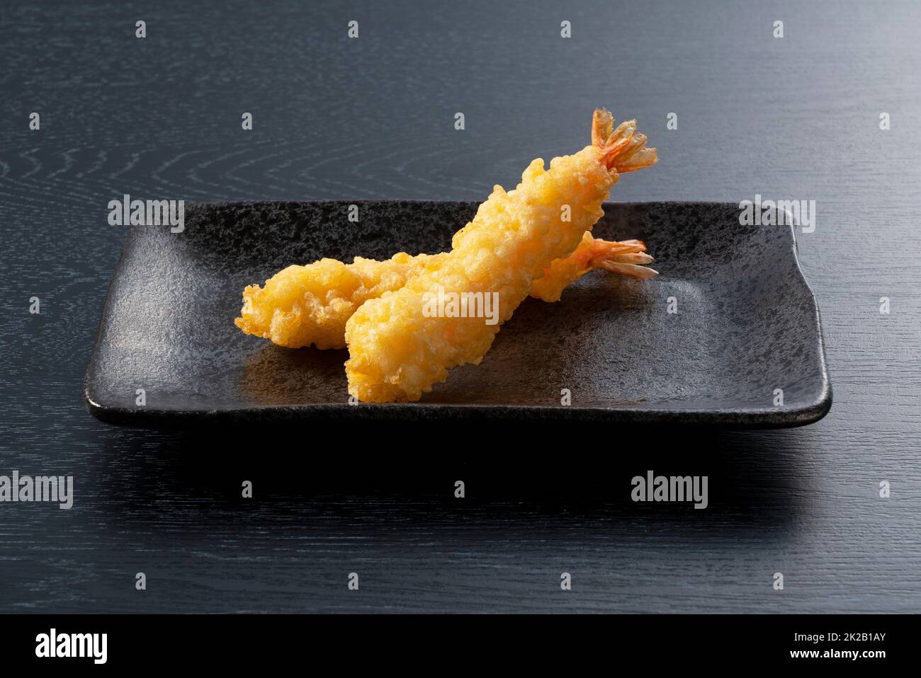 Shrimp tempura on a plate placed against a black background Stock Photo ...