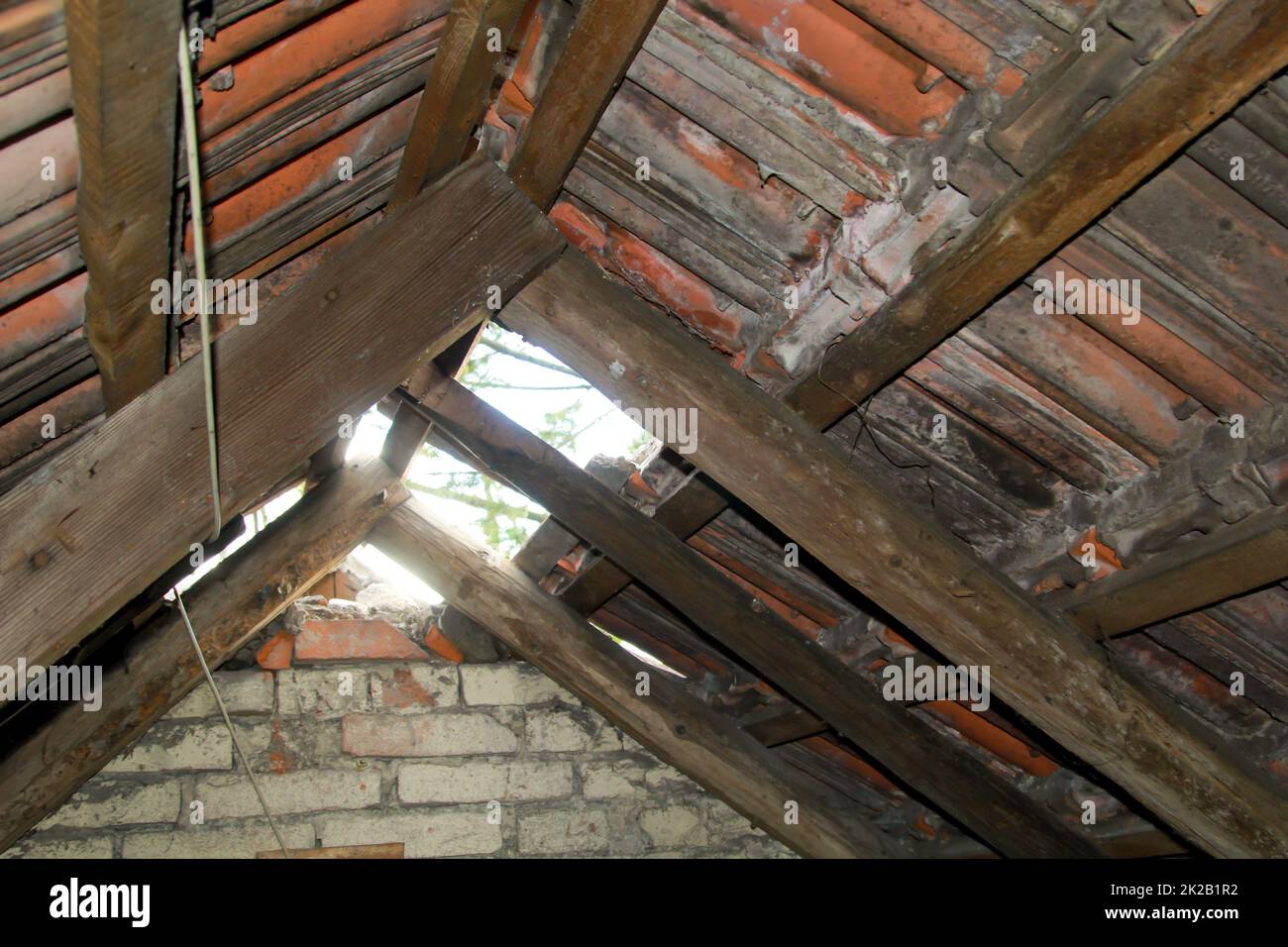 The damage to the roof after a strong storm, roof tiles are torn off ...