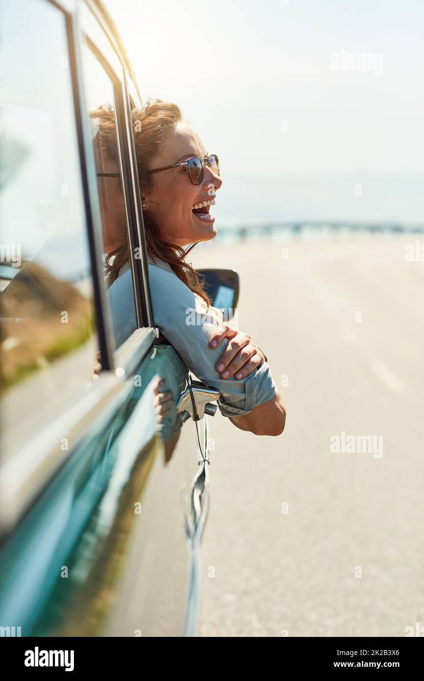 Feeling free on the open road. Cropped shot of an attractive woman ...