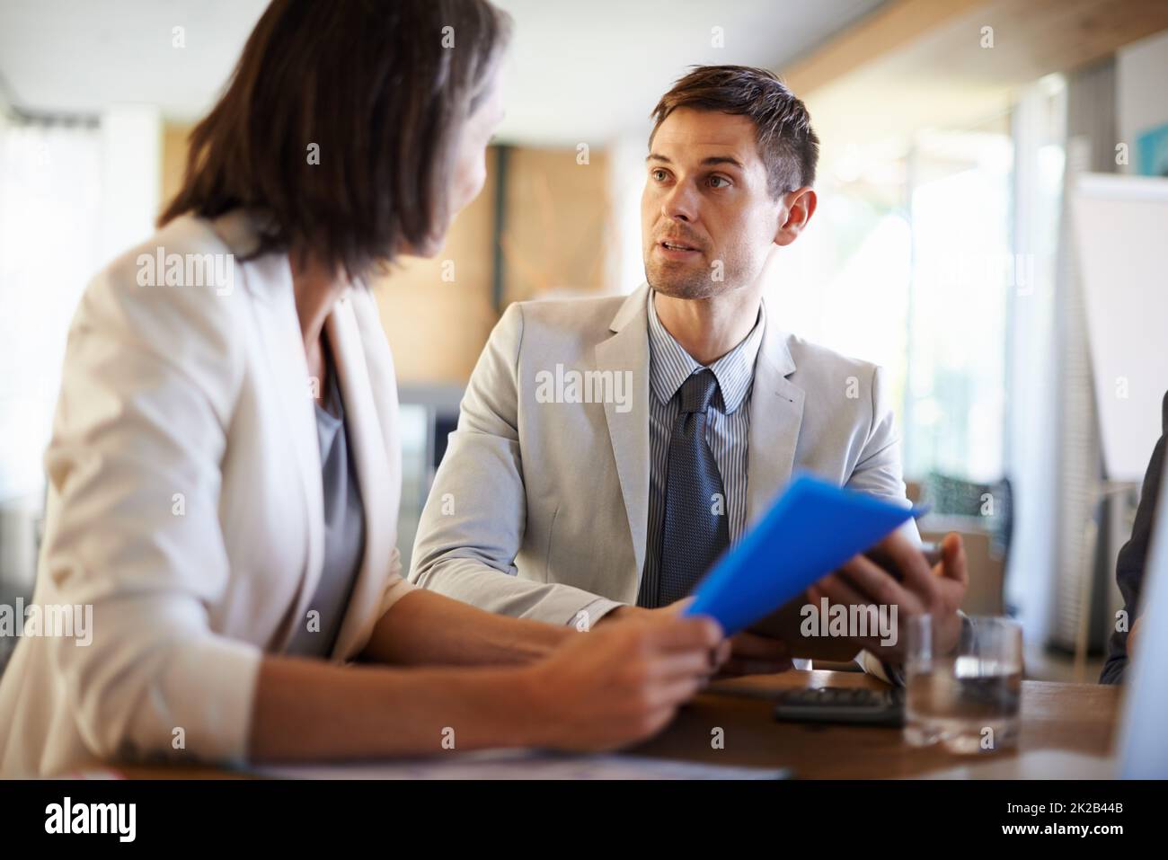 They have a lot on their plate today. Two businesspeople having an ...