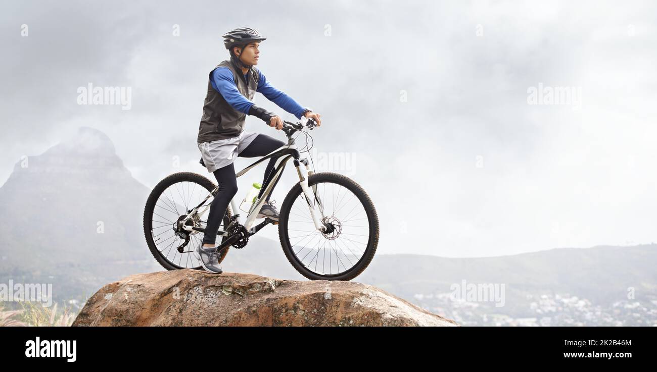 Out for a mountain bike ride. A young man on a mountain bike with a ...