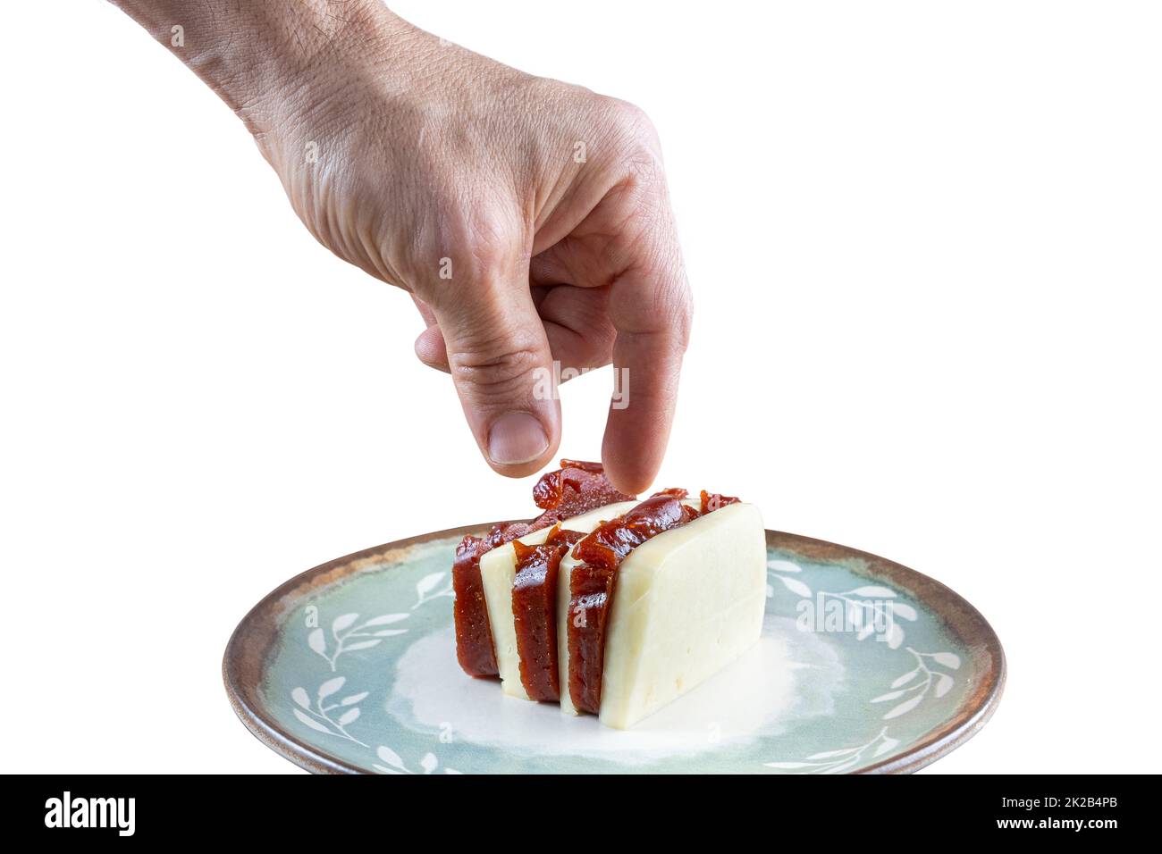 Closeup of man's hand going to pick up slices of guava sweet and curd ...