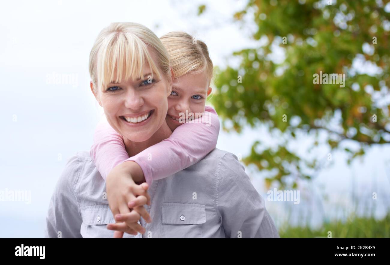 Shes my pride and joy. A beautiful young mother smiling as she gives ...